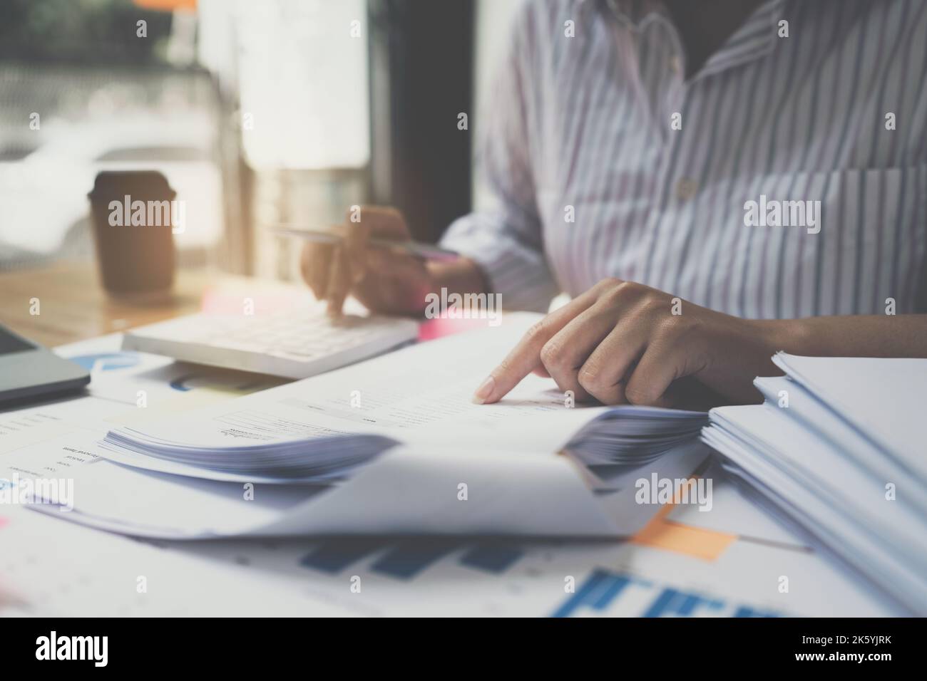 Business woman using calculator for audit finance budget on wooden desk ...