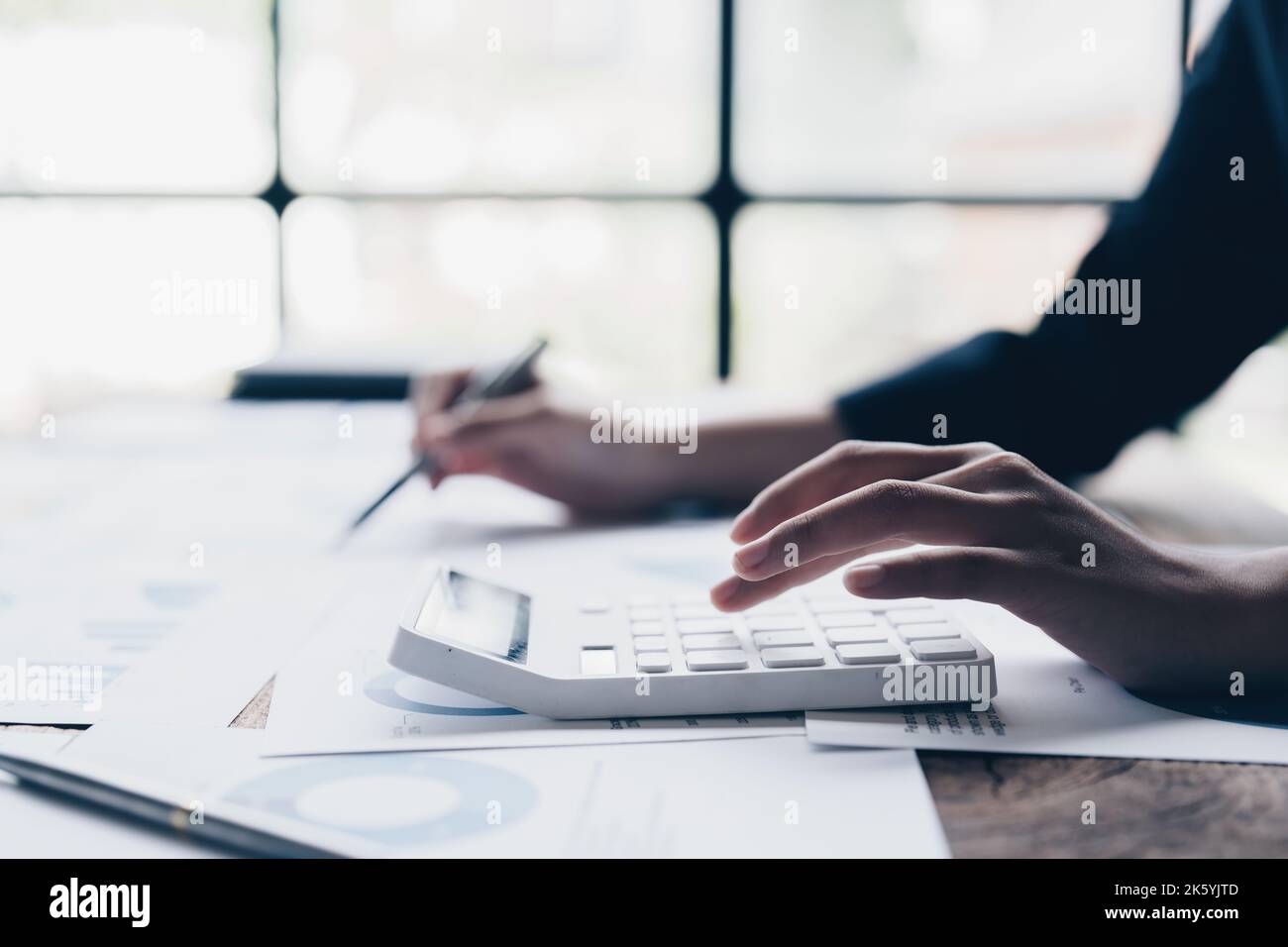 Close up Business woman hand using calculator to calculate the company ...