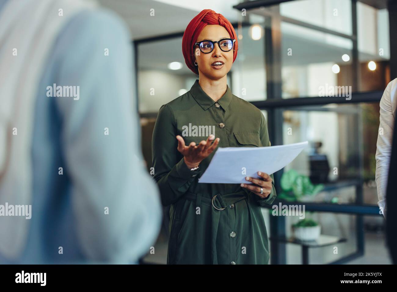 Confident businesswoman having a meeting with her colleagues in a ...