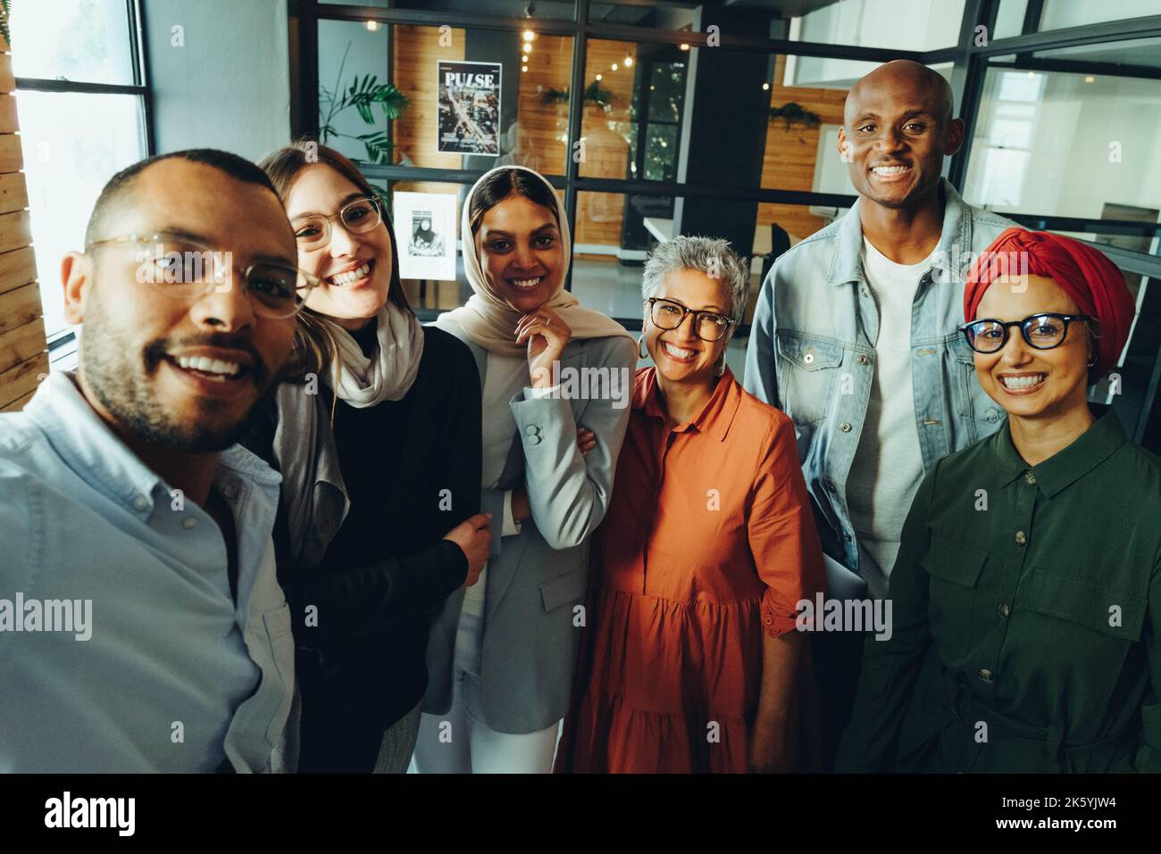 Happy business colleagues smiling at the camera while taking a staff ... Happy business colleagues smiling at the camera while taking a staff ...