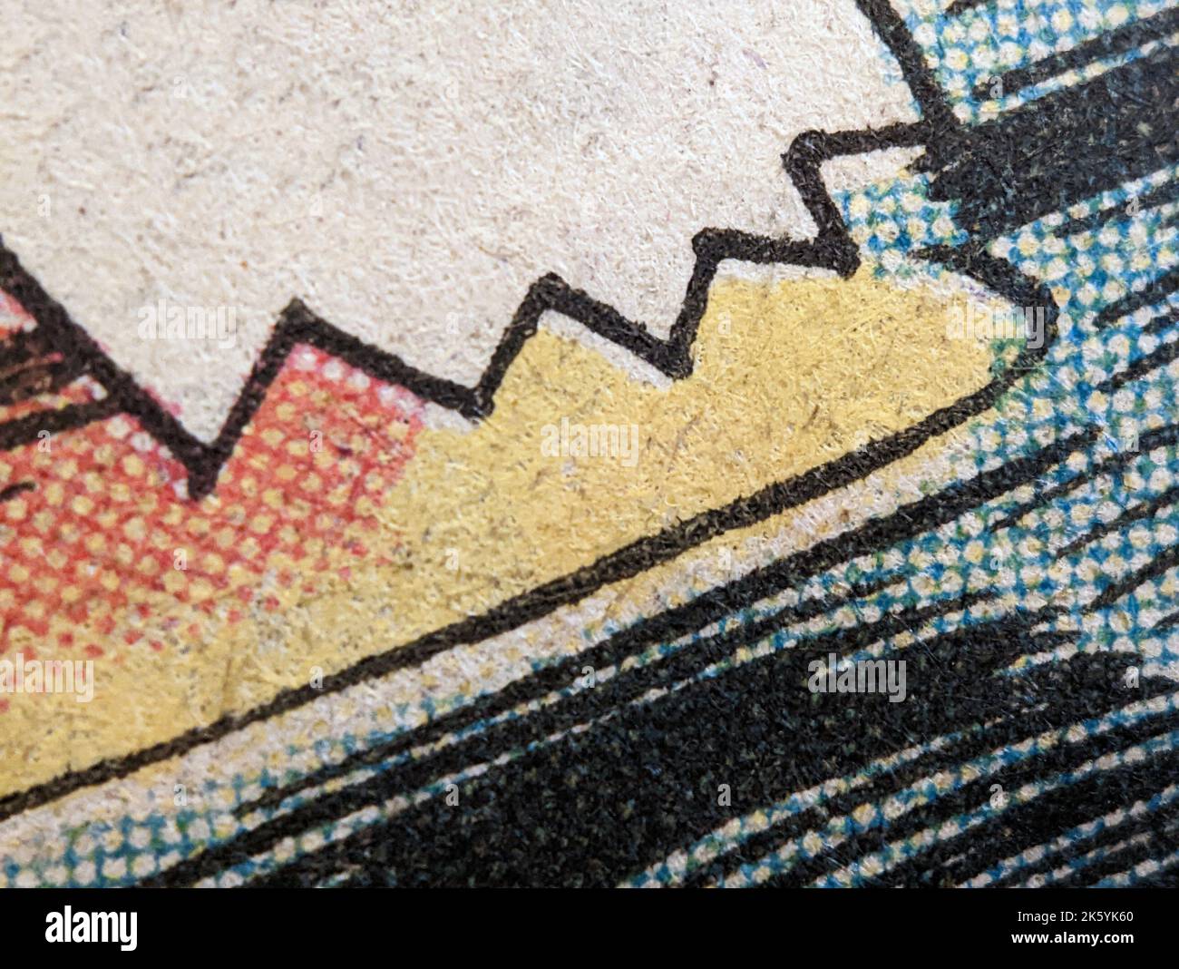 Closeup photo of a real vintage comic book page with yellow red and ...