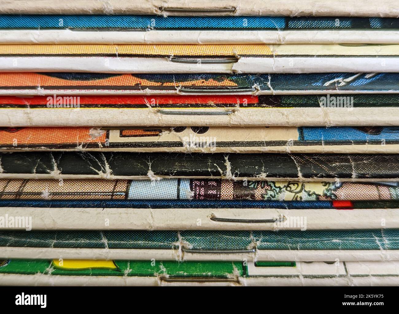 Stack of old vintage comic books creates a colorful background texture ...