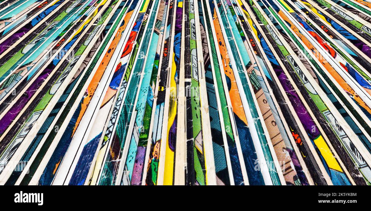 Old comic books stacked in a pile creates a colorful background texture ...