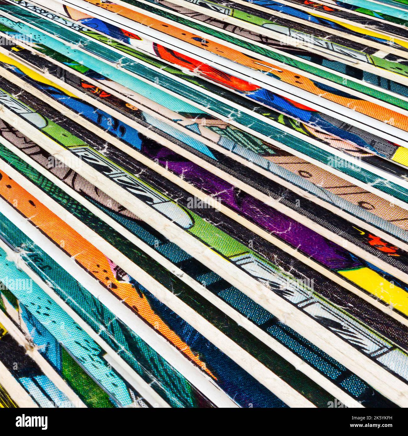 Old comic books stacked in a pile creates a colorful background texture ...