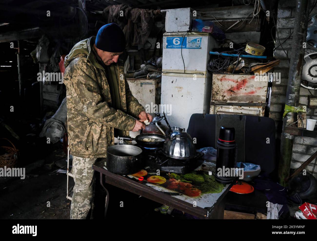 A Ukrainian soldier seen preparing potatoes for breakfast at a military ...