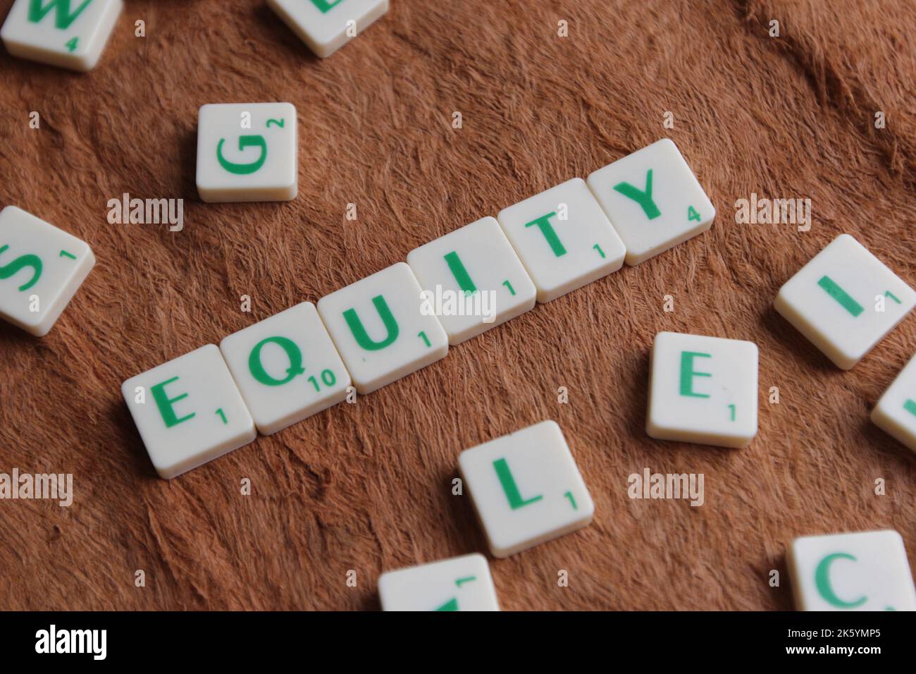 Scrabble tiles reading out the words EQUITY Stock Photo - Alamy