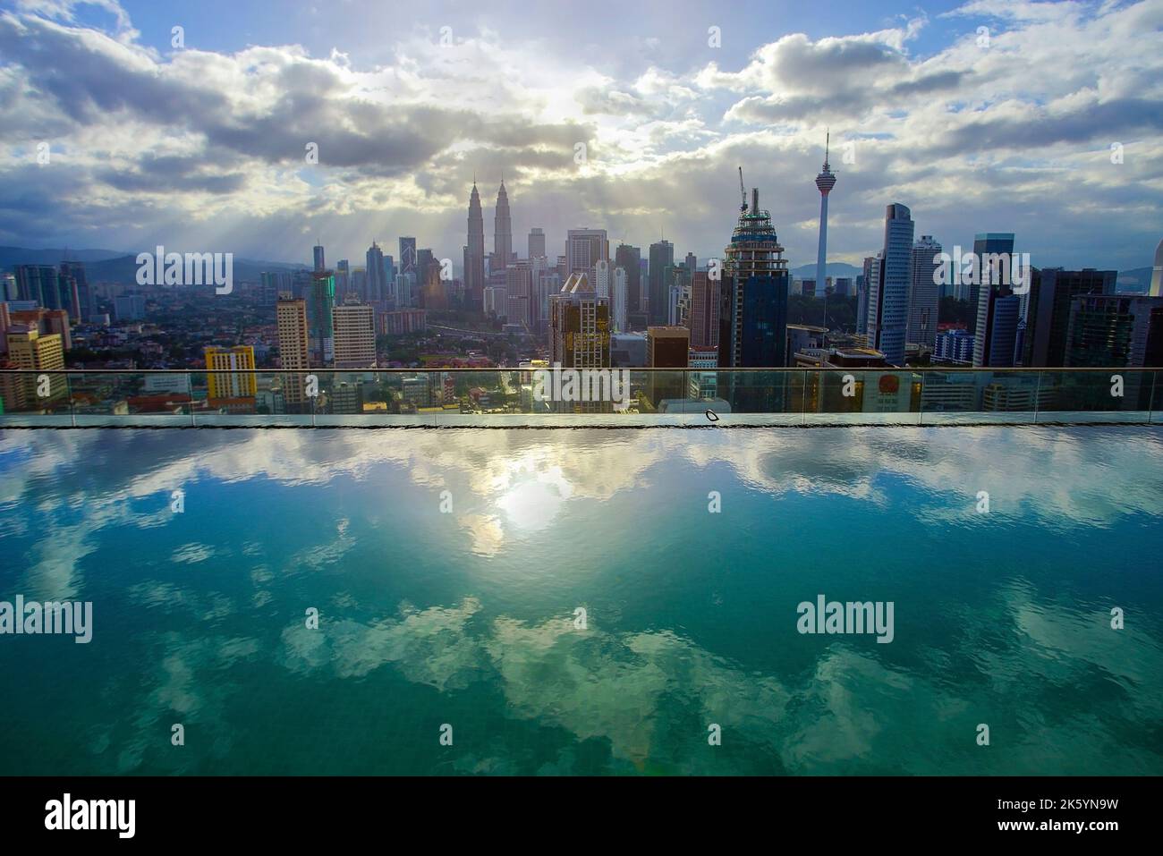 Kuala Lumpur city skyline with dramatic ray of light and cloud ...