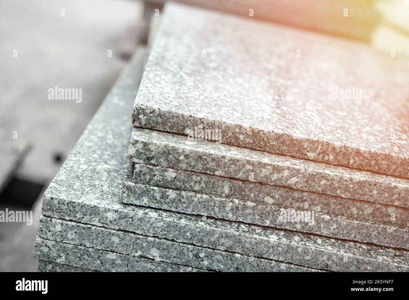 Gray granite polished tiles stacked outdoors before laying on the floor ...
