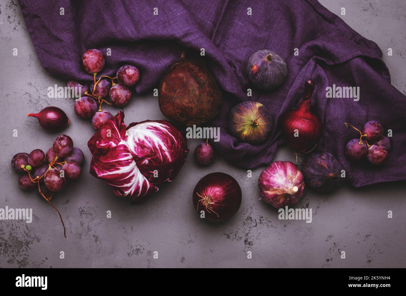 Autumn food background with purple vegetables, roots and fruits ...