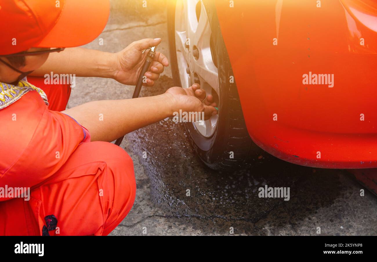 Jakarta, Indonesia 10 October 2022 : Close up mechanic inflating tire ...