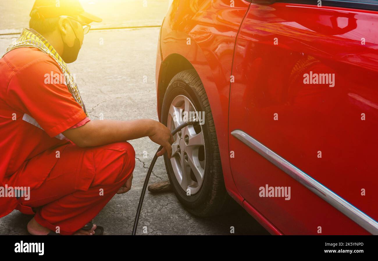 Jakarta, Indonesia 10 October 2022 : Close up mechanic inflating tire ...