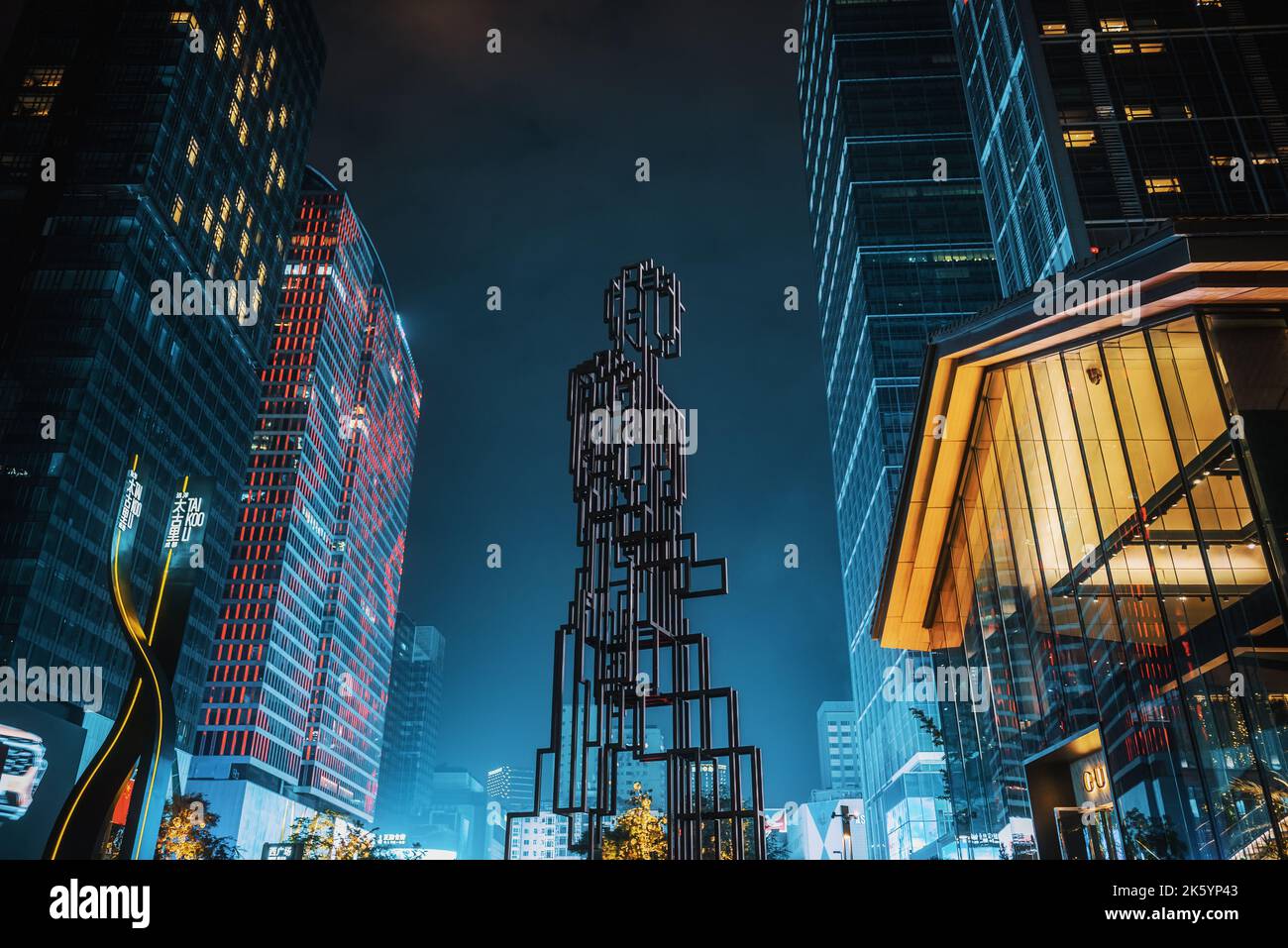 Illuminated skyscrapers and metallic statue at night in Chengdu Stock ...