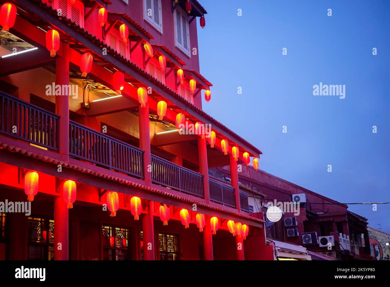 Red building and lantern during blue hour Stock Photo - Alamy