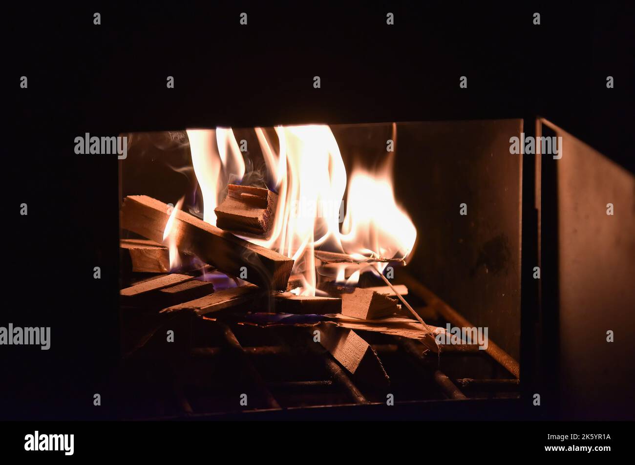 Fire burns in metal stove hi-res stock photography and images - Alamy