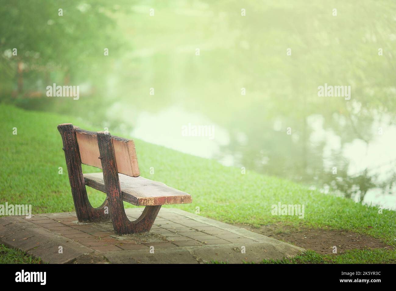 Lonely chair near lake and nature background Stock Photo - Alamy