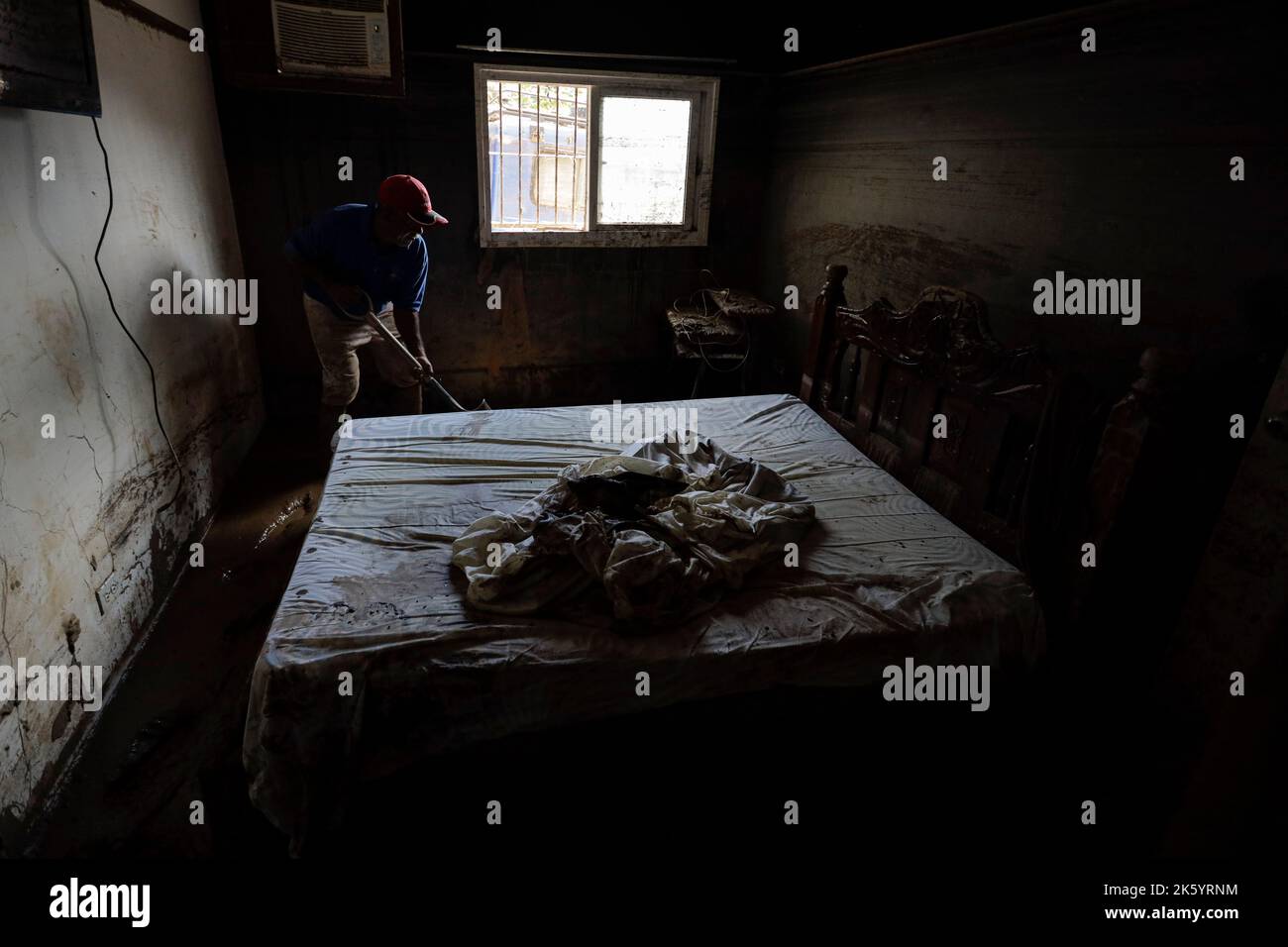 Las Tejerias, Venezuela. 10th Oct, 2022. A man removes mud from a ...