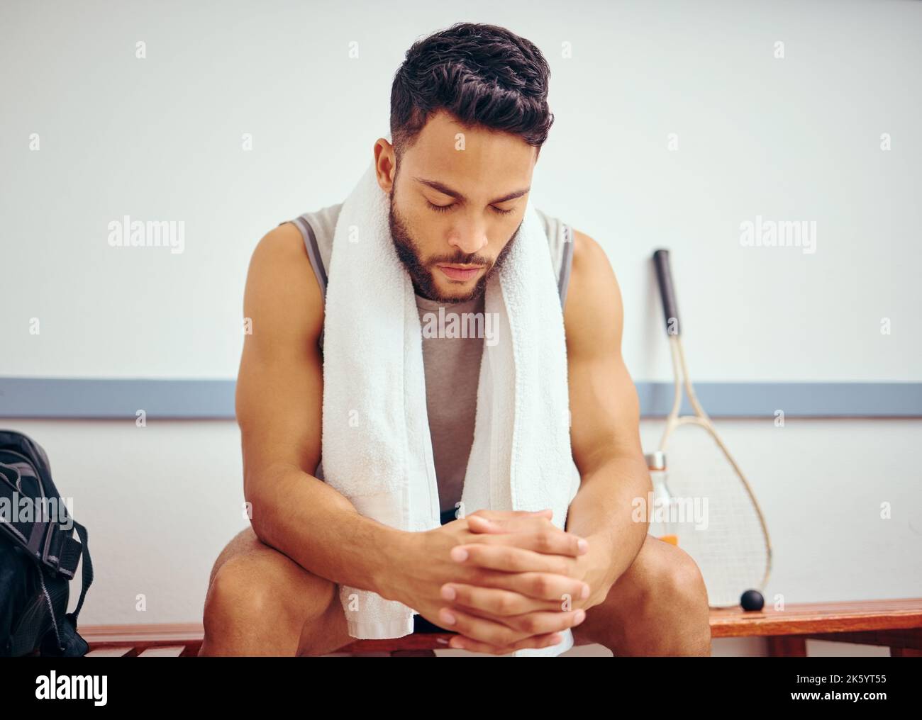 Hispanic player with his eyes closed in a locker room. Young man ...
