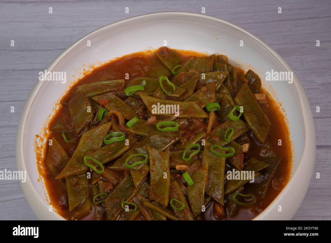 Recipe for flat green beans in tomato sauce Stock Photo - Alamy