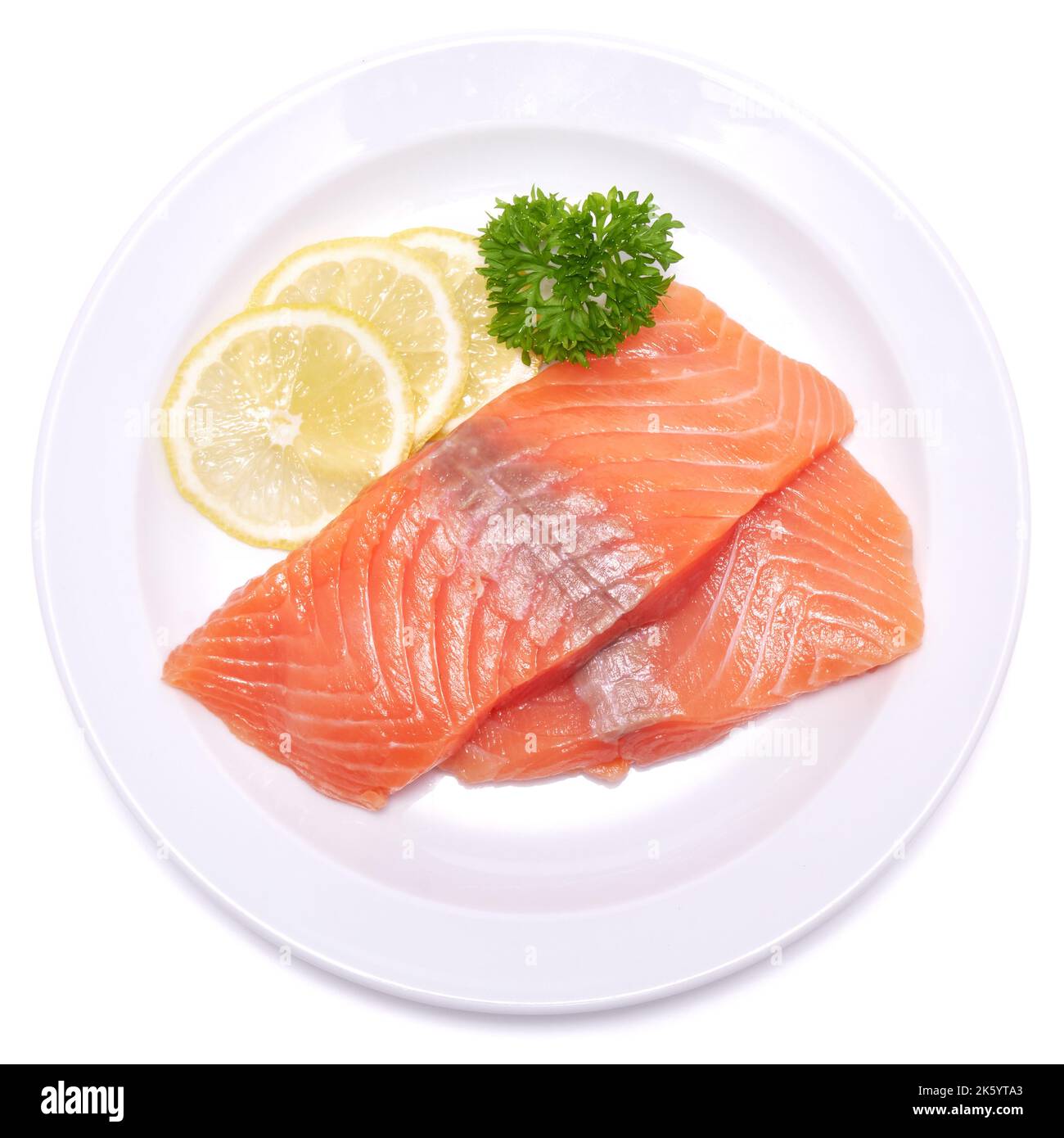 piece of salmon fillet on a ceramic plate isolated on white background ...