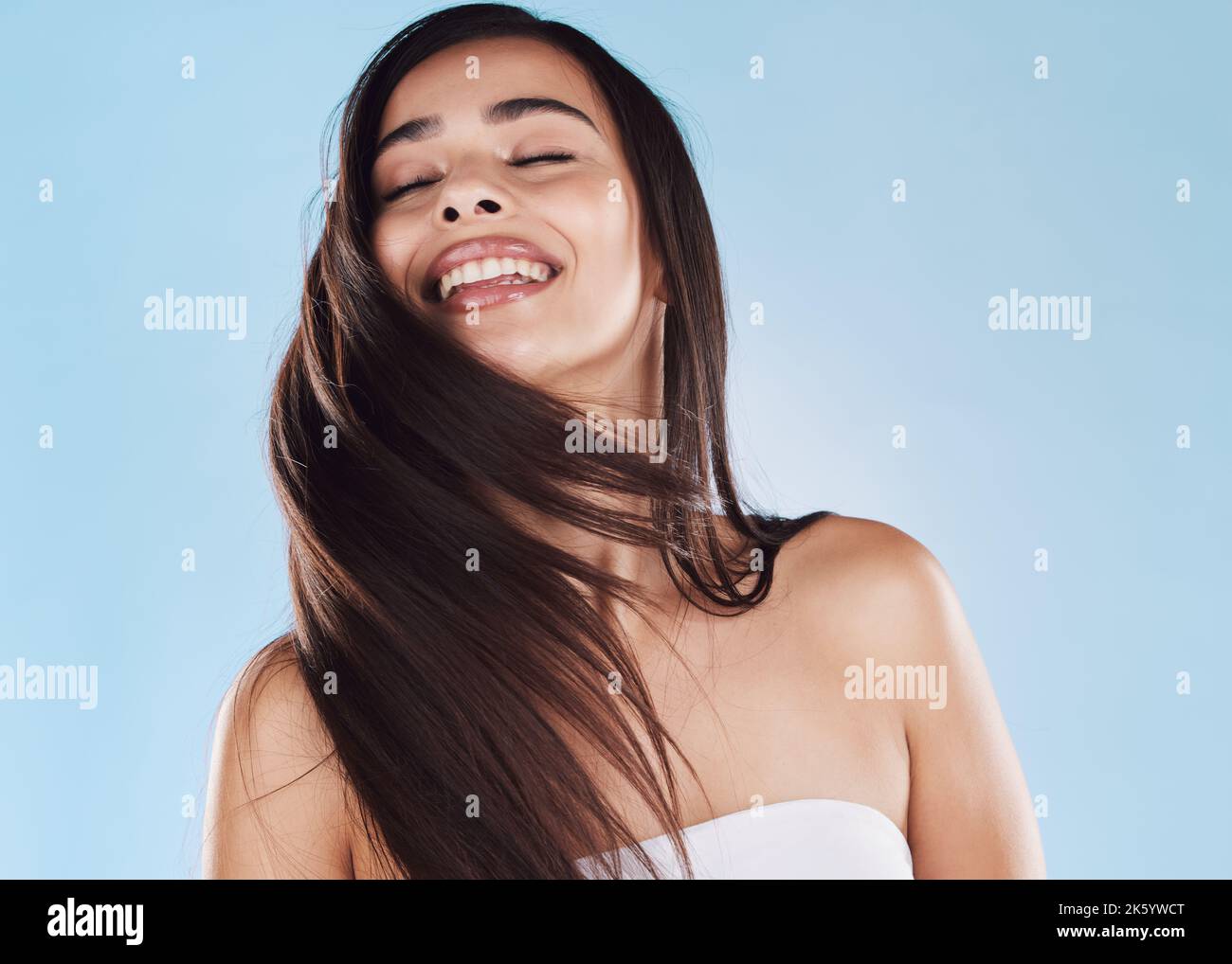 One beautiful young hispanic woman with healthy skin tossing her sleek ...