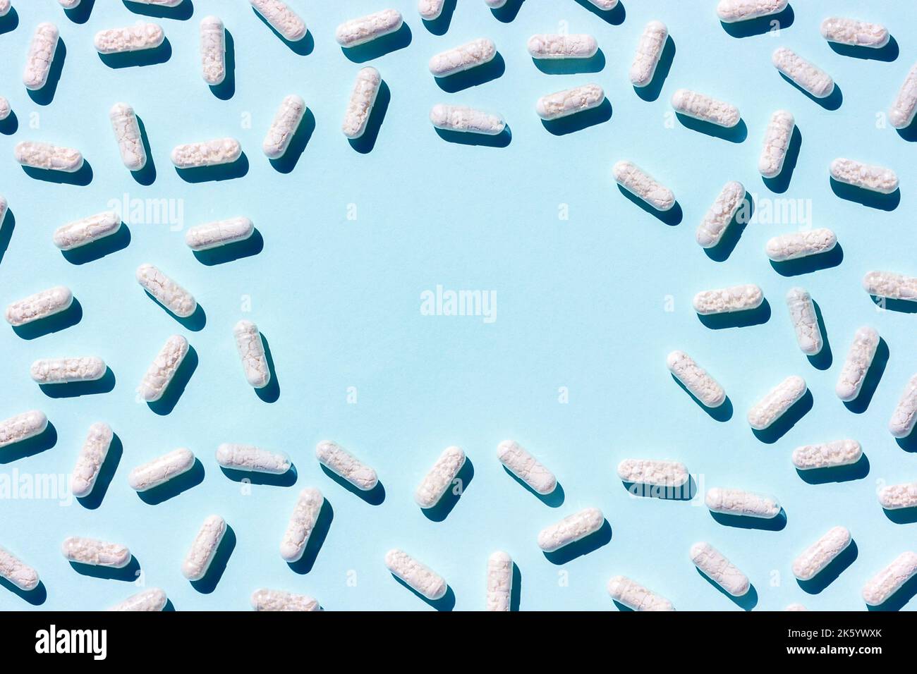 Frame made with pills on blue background. Creative medicine border for ...