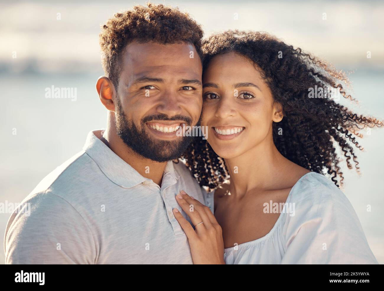 Closeup portrait of an young affectionate mixed race couple standing on ...