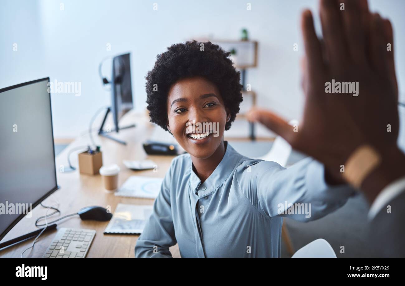 Happy african american call centre telemarketing agent giving colleague ...