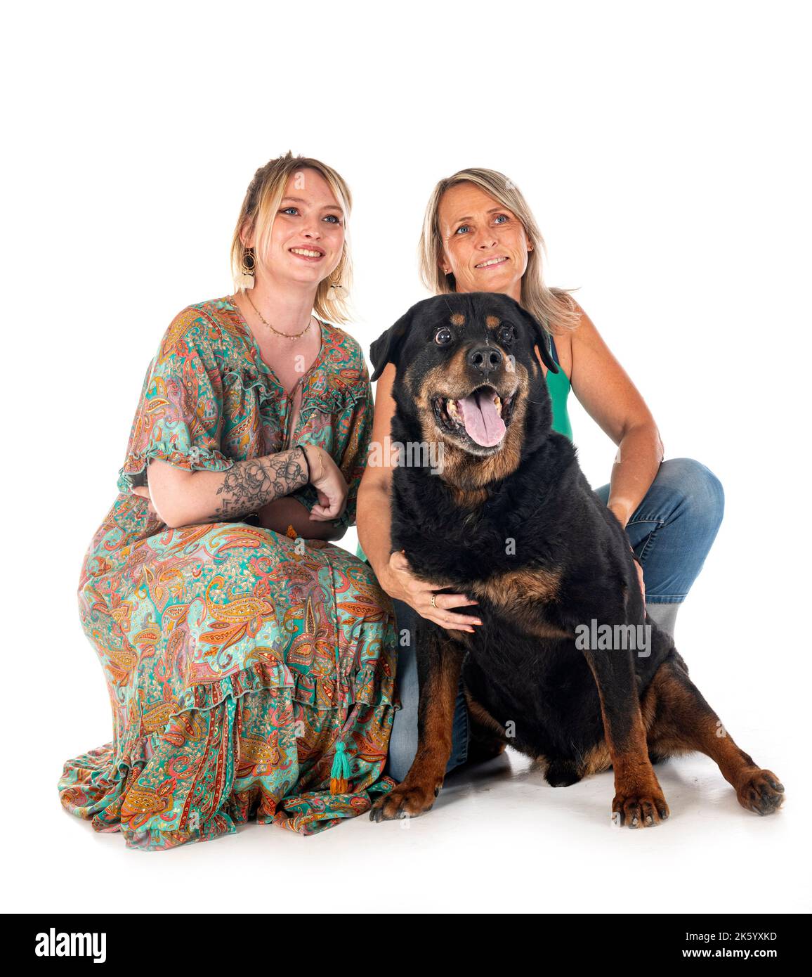 purebred old rottweiler fourteen year and his owners in front of white ...