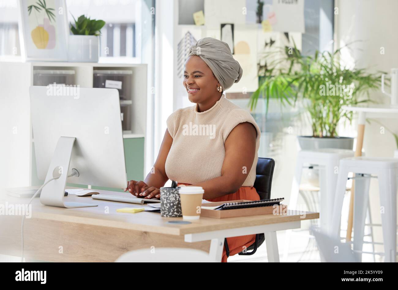 Happy young african american businesswoman smiling while using a ...