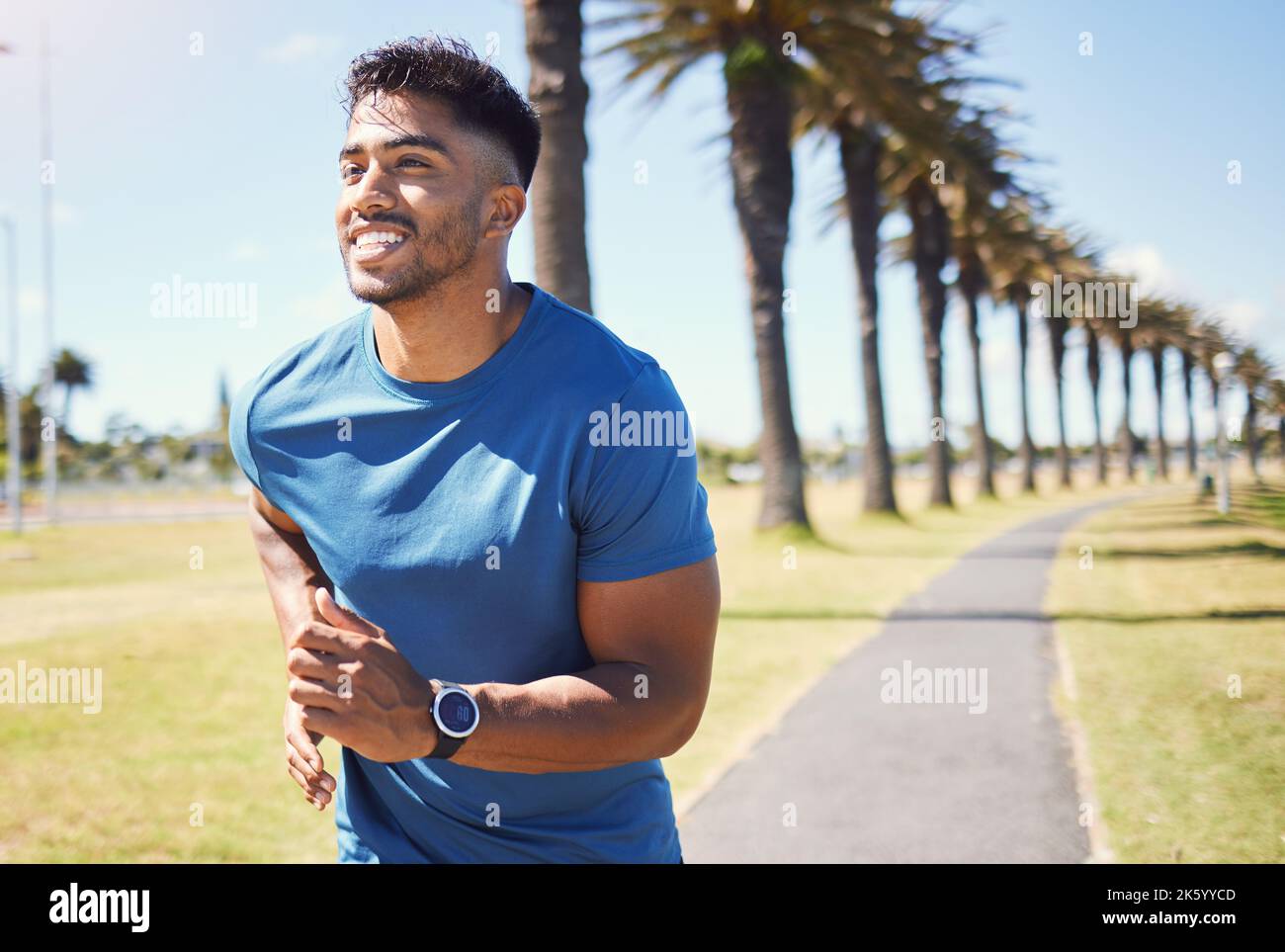 Fit hispanic athlete wearing a smartwatch to track his progress while ...