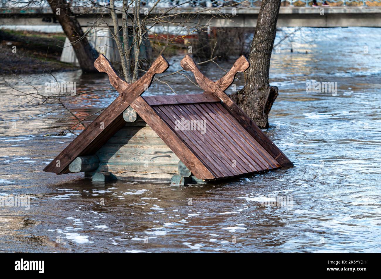 to the roof of a bird house flooded in spring floods - a feeder on the ...