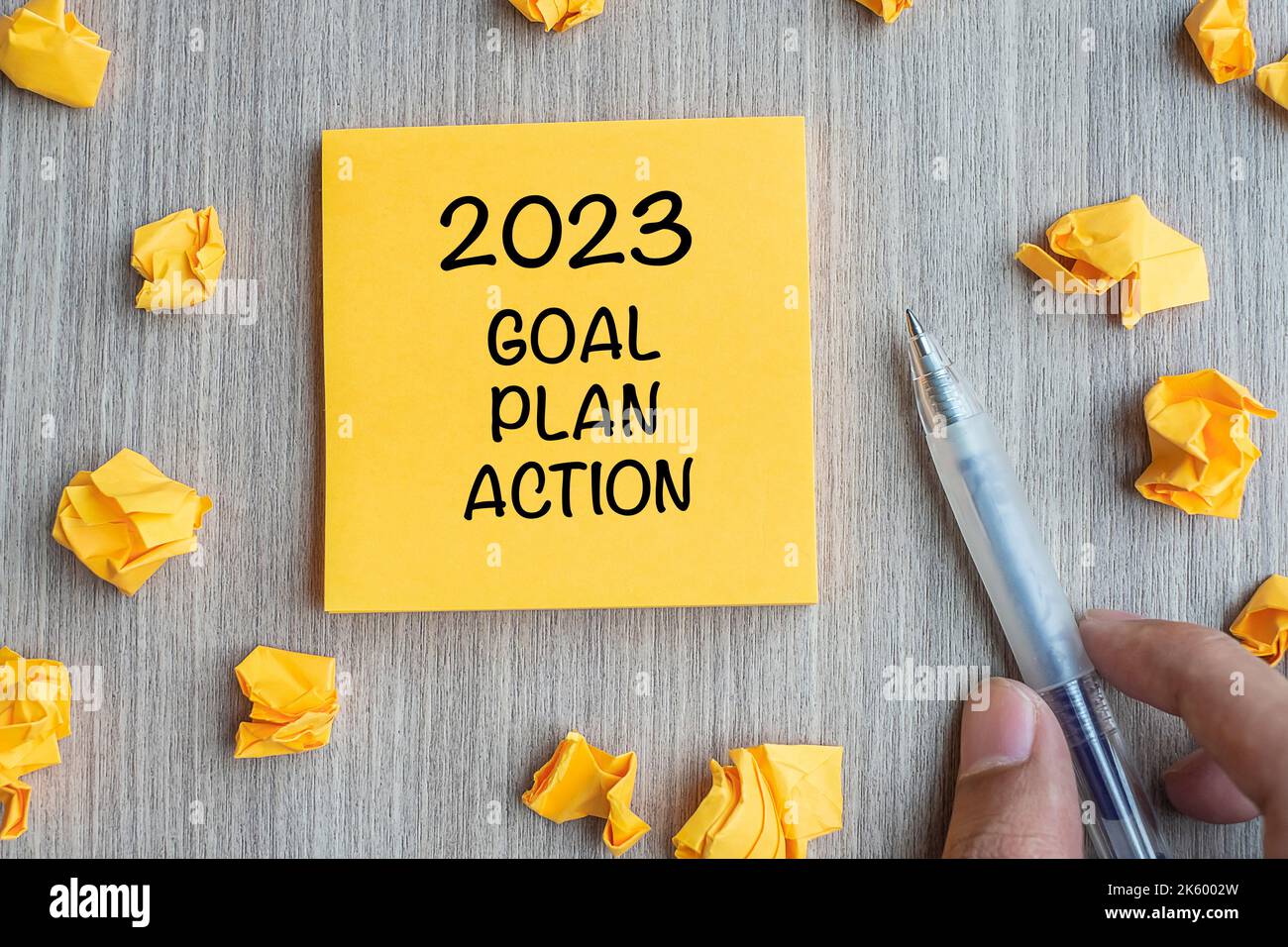2023 Goal, Plan, Action word on yellow note with Businessman holding ... 2023 Goal, Plan, Action word on yellow note with Businessman holding ...