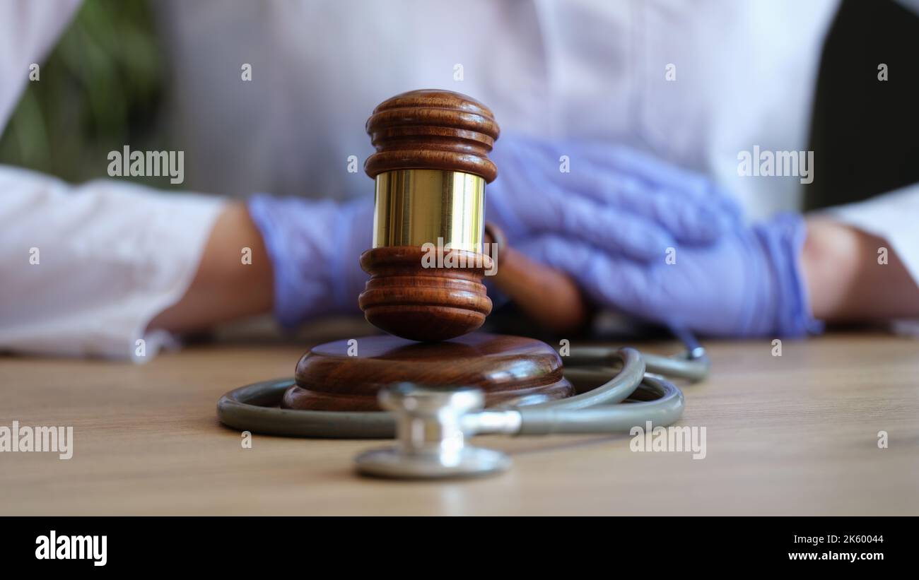 Female hands in gloves striking with judge hammer Stock Photo - Alamy