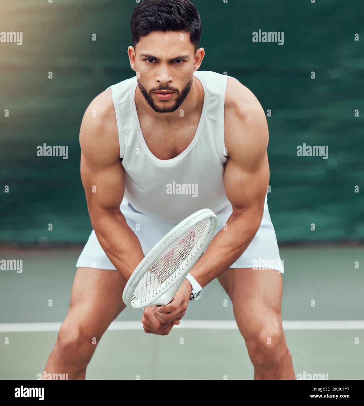 Portrait of mixed race tennis player holding racket and ready to play ...