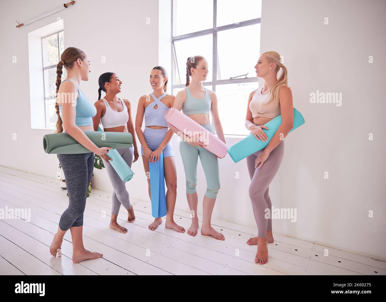 Friends talking before yoga class. Group of women bonding before ...