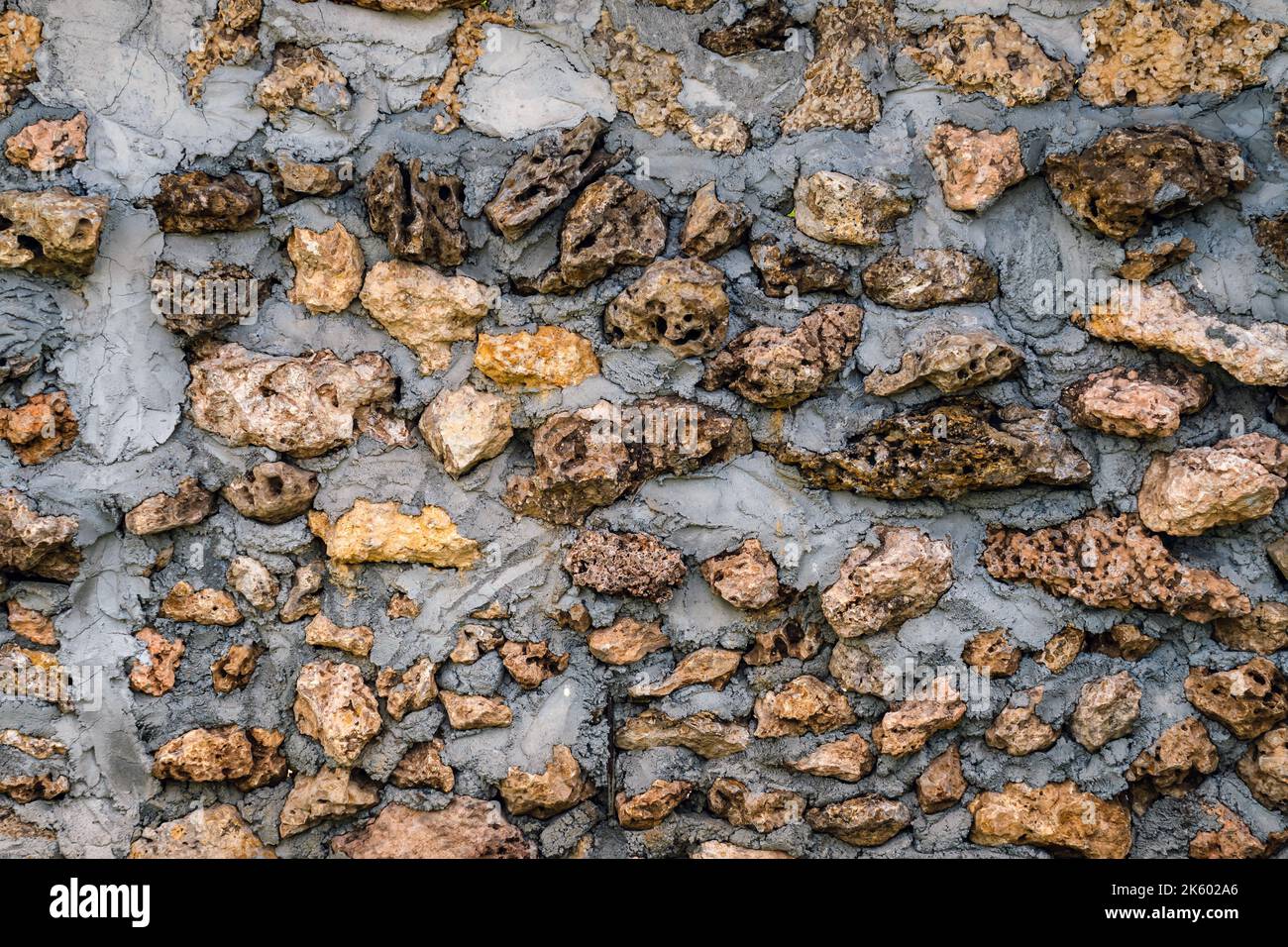 Old style wall made of rough stones with cement. Ancient grunge stones ...