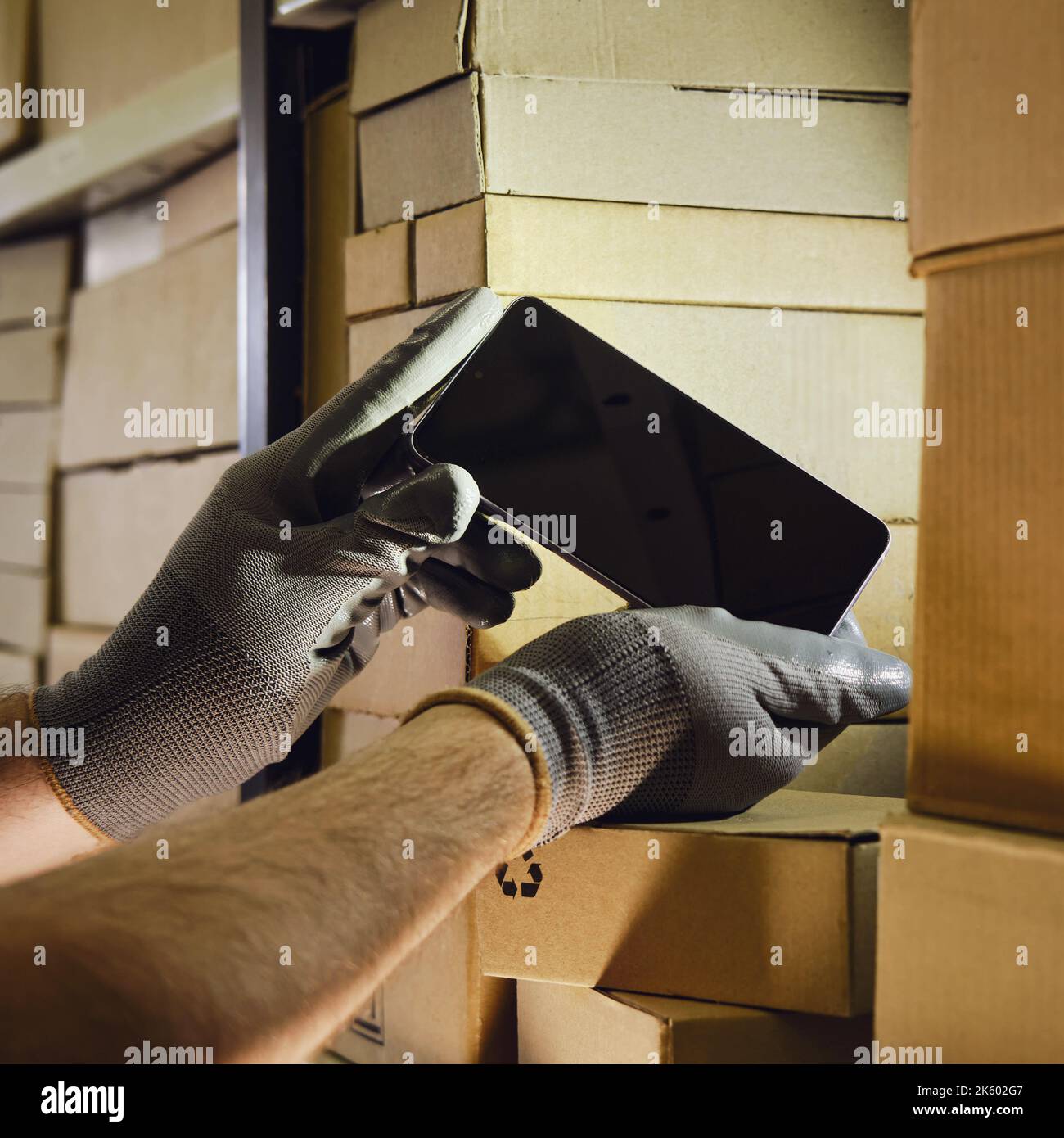 Phone is in the hands of a man warehouse worker. The crisis of ...