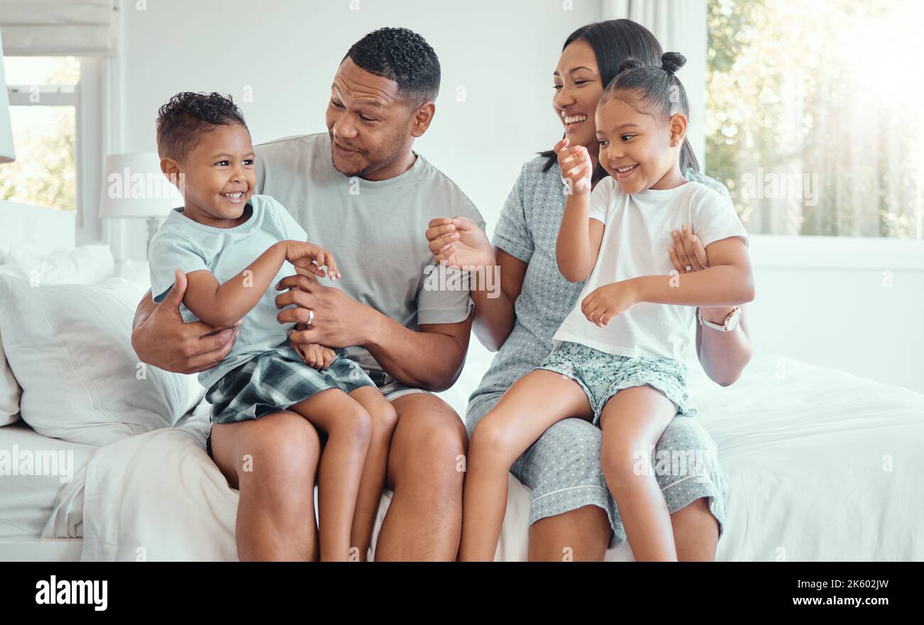 Happy funny mixed race family with two children wearing pyjamas and ...