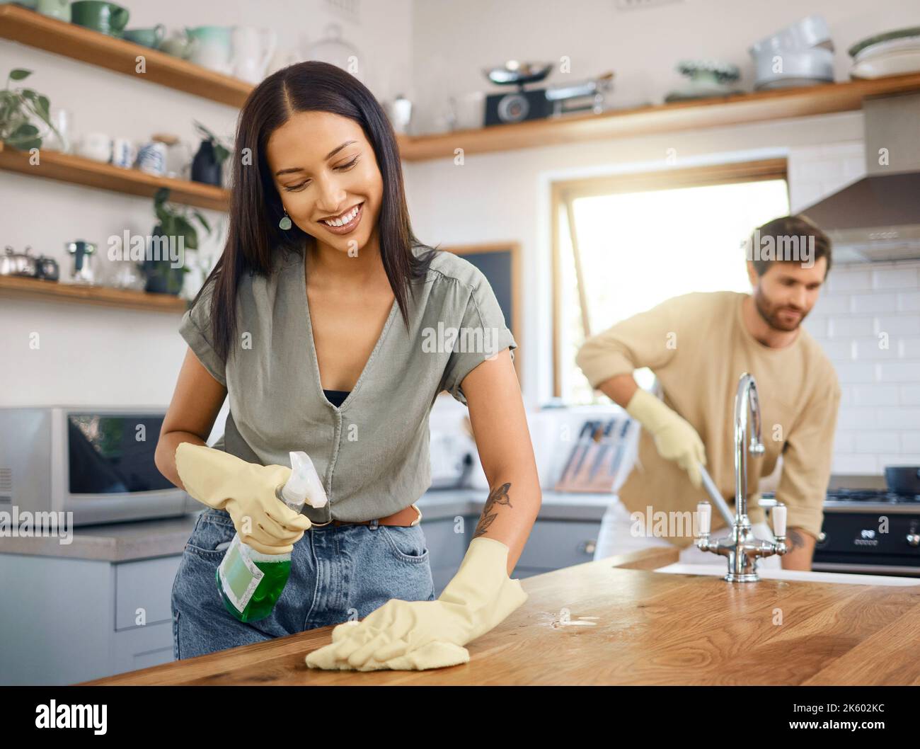 Happy Young Interracial Couple Cleaning Their Home Young Man And Woman