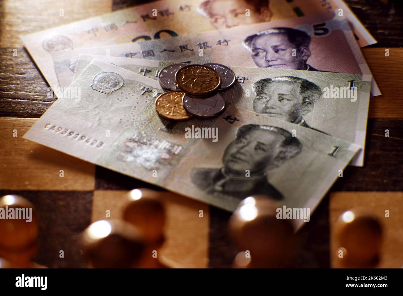 Chinese yuan money on the background of a chess board. Banknotes and ...