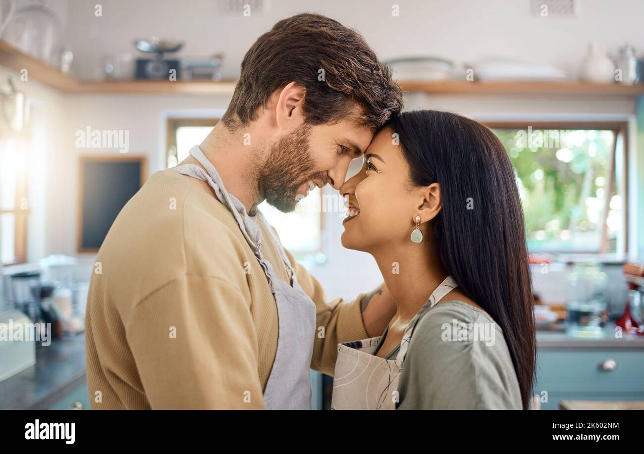 Happy Interracial Couple Touching Foreheads While Sharing Romantic