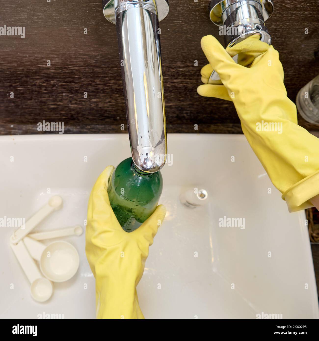 Creating a chemical solution in the sink to treat plants from parasites ...