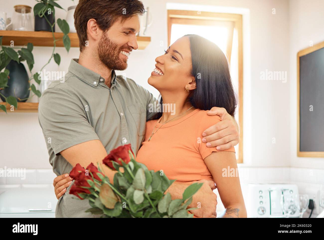 Young caucasian boyfriend giving his mixed race girlfriend a bouquet of ...