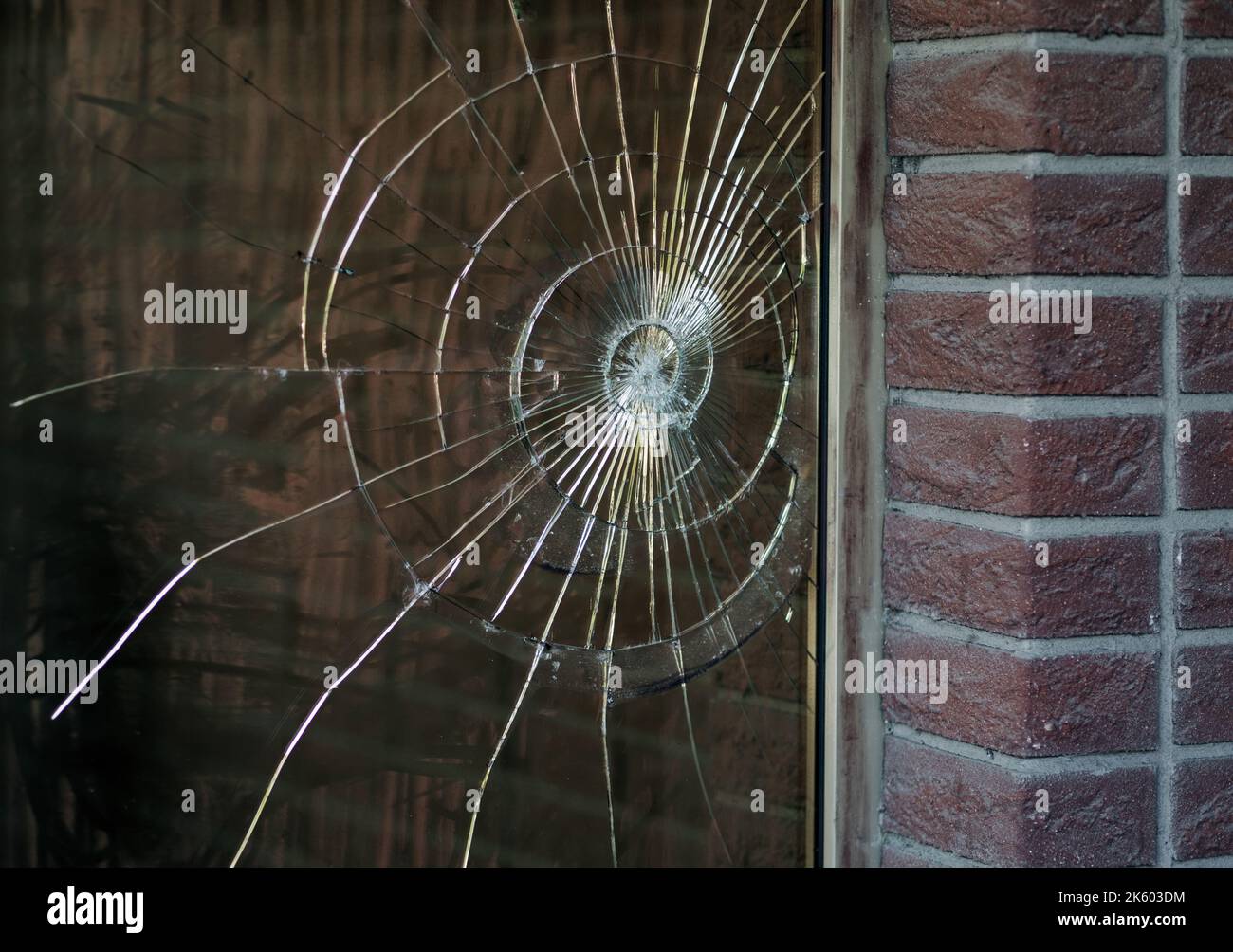 broken cracked glass with hole. crime and damage Stock Photo - Alamy