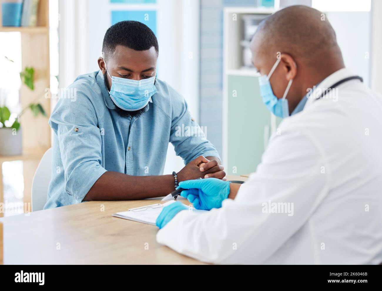 Doctor and patient talking about covid test results. African american ...
