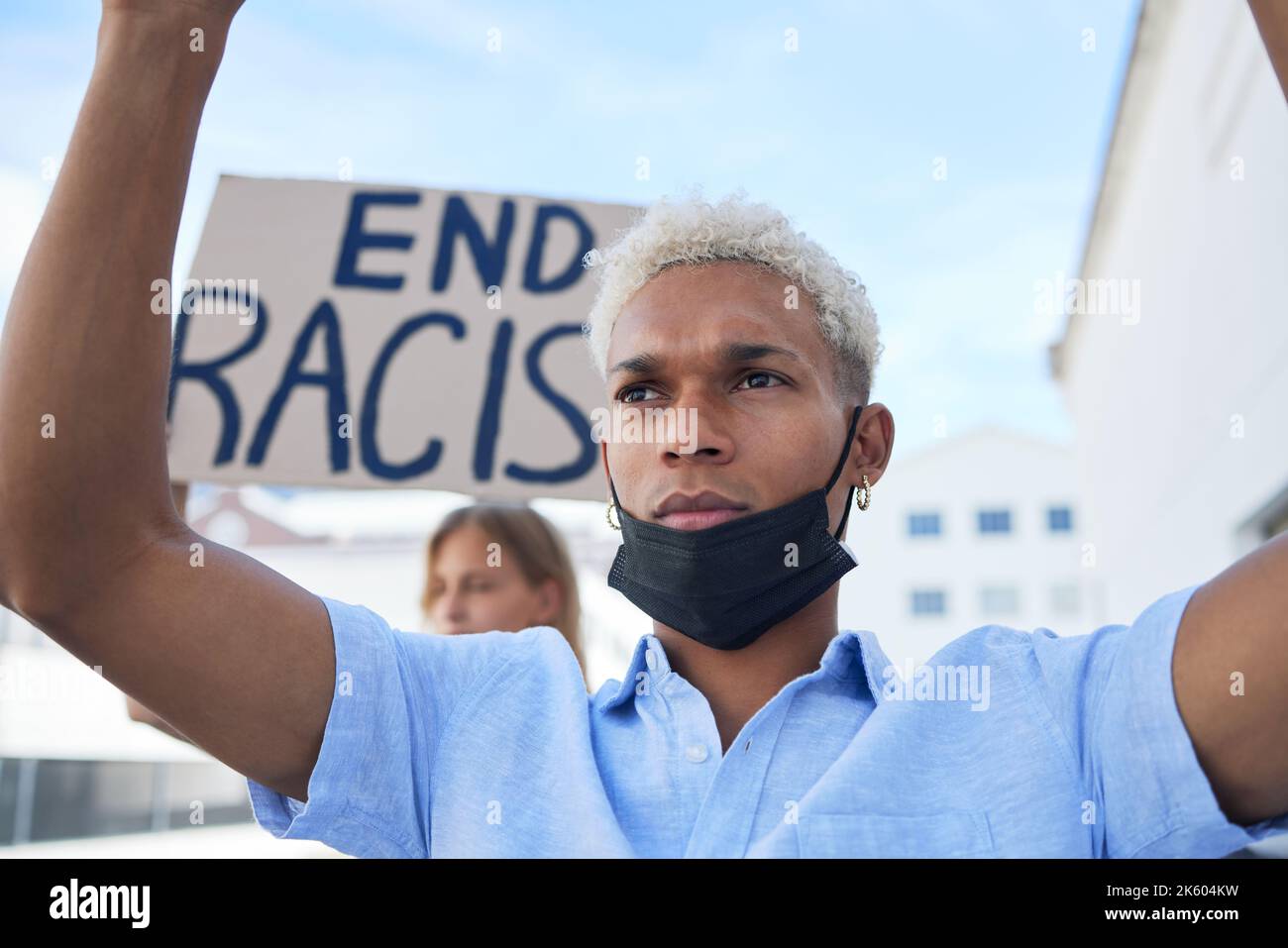 End racism sign, poster and black man protest in face mask, cardboard ...