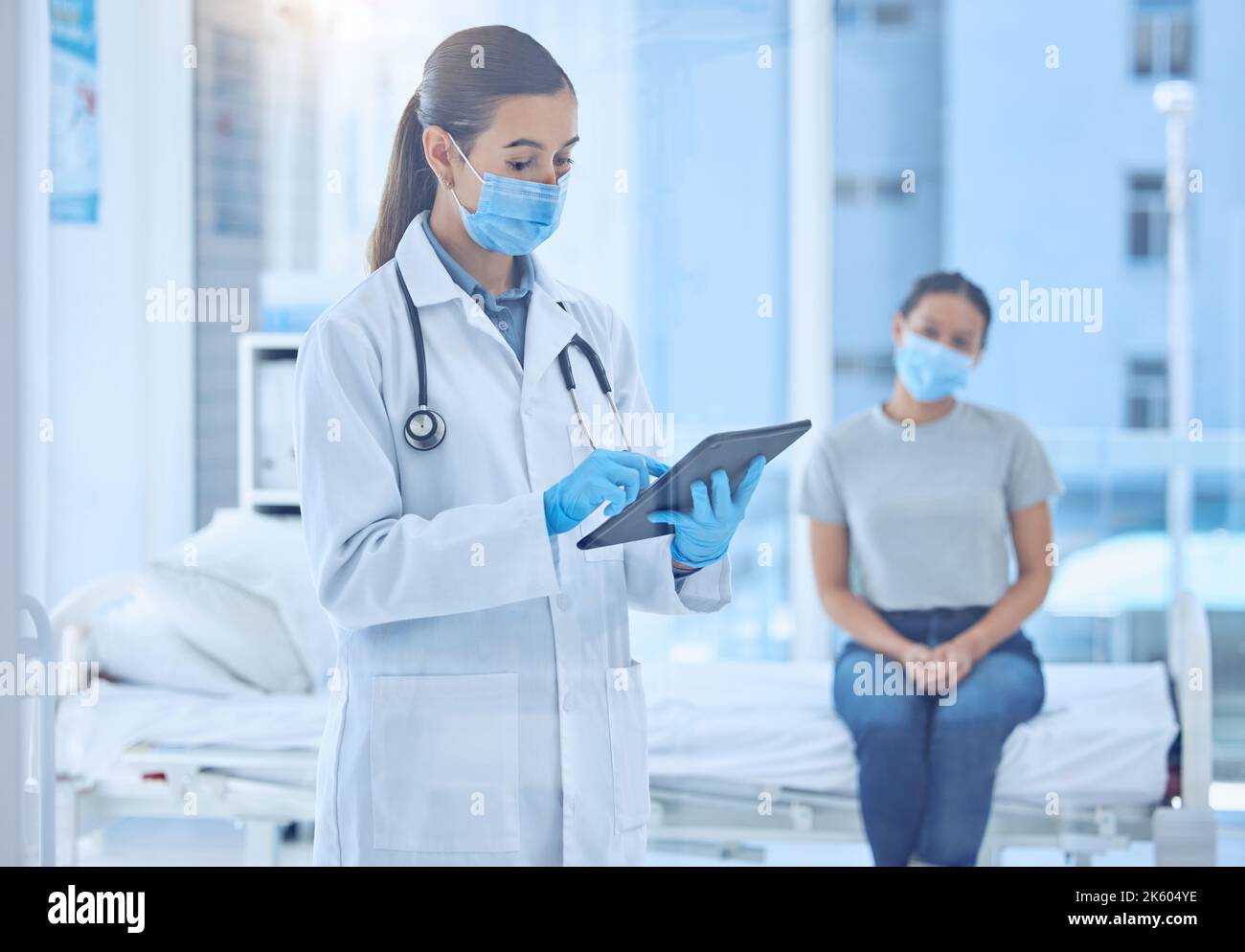 Doctor checking a patients covid test results. Patient in consult for ...