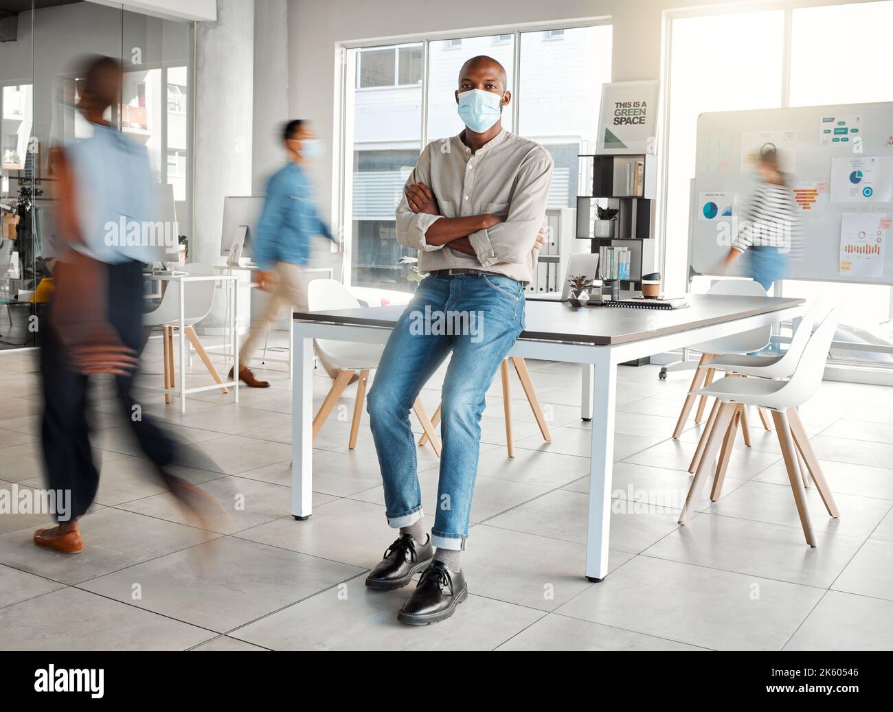 Young African american businessman standing with his arms crossed and ...