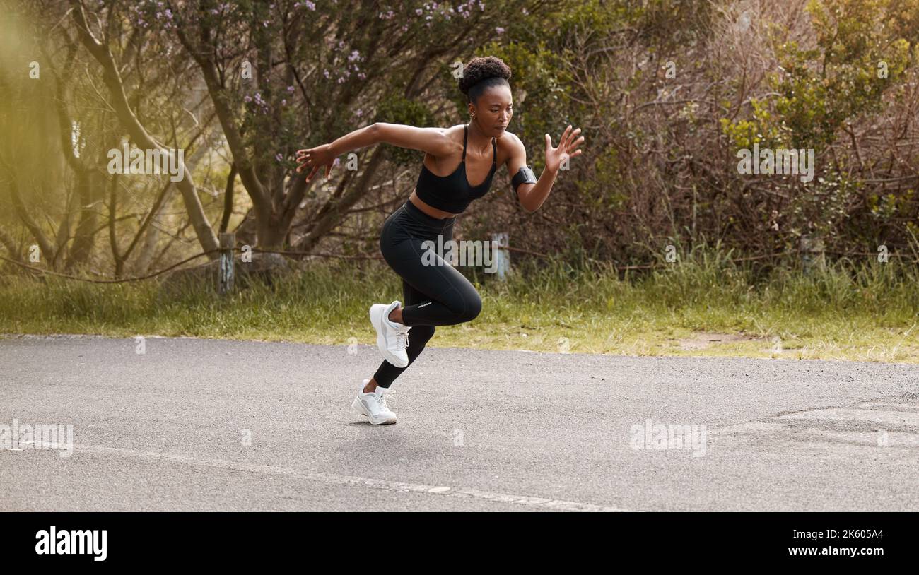 One african american female athlete looking focused while out for run ...