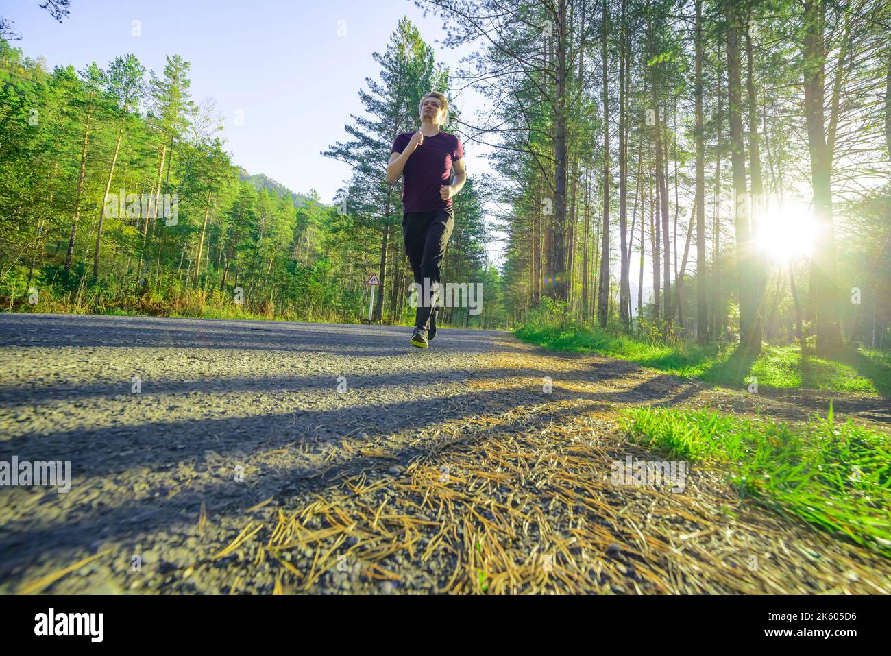 Running man jogging in city park at beautiful summer day. Sport fitness ...
